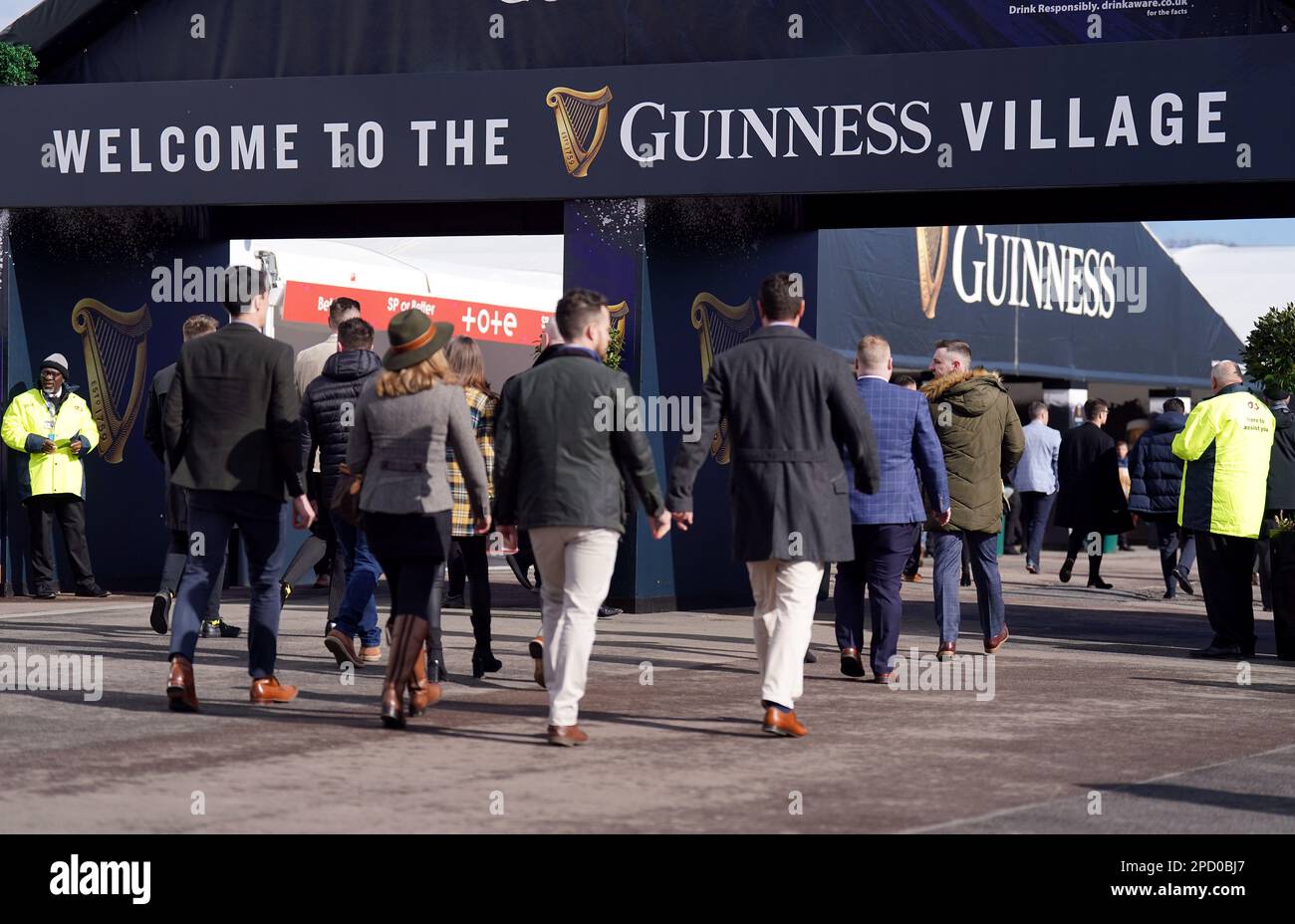 Racegoers enter the Guinness village on day one of the Cheltenham ...