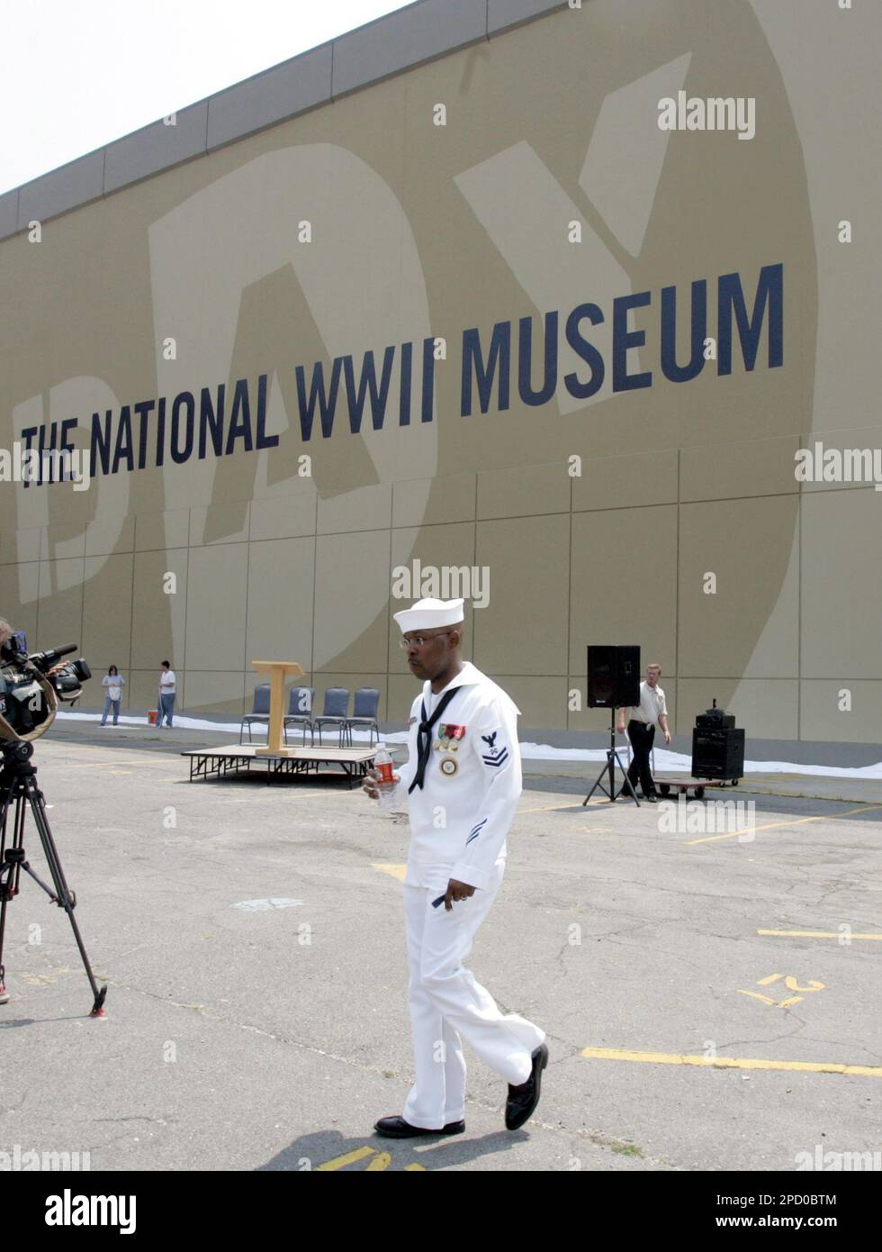 **FILE**U.S. Navy's Kermit Lewis, Sr. walks past the new logo of the ...