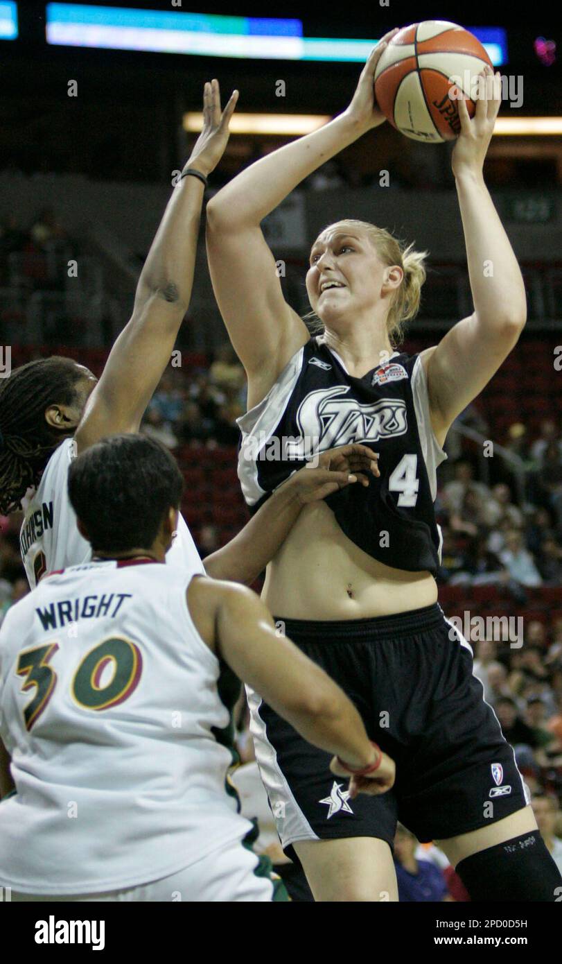 San Antonio Silver Stars' Katie Feenstra, right, goes to the basket as ...