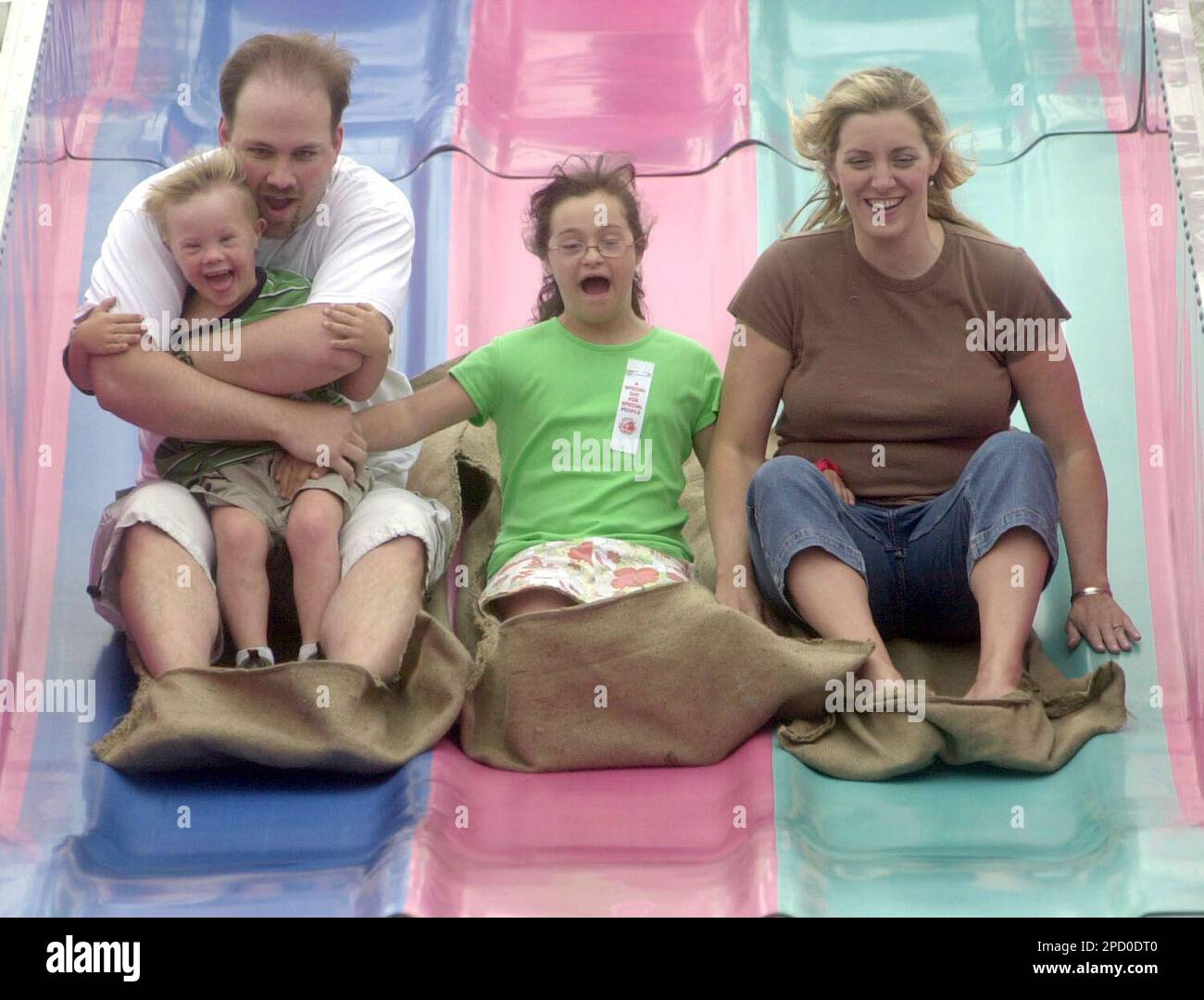 Clutching his dad's arms Seth Schlaack, 5, screams as he slides down ...