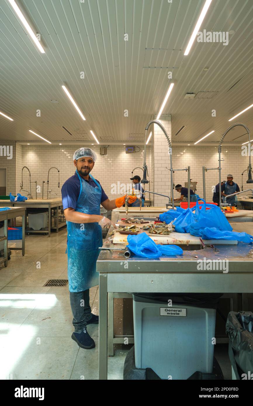 Men busy cleaning, gutting, prepping someone's purchased fish, seafood ...