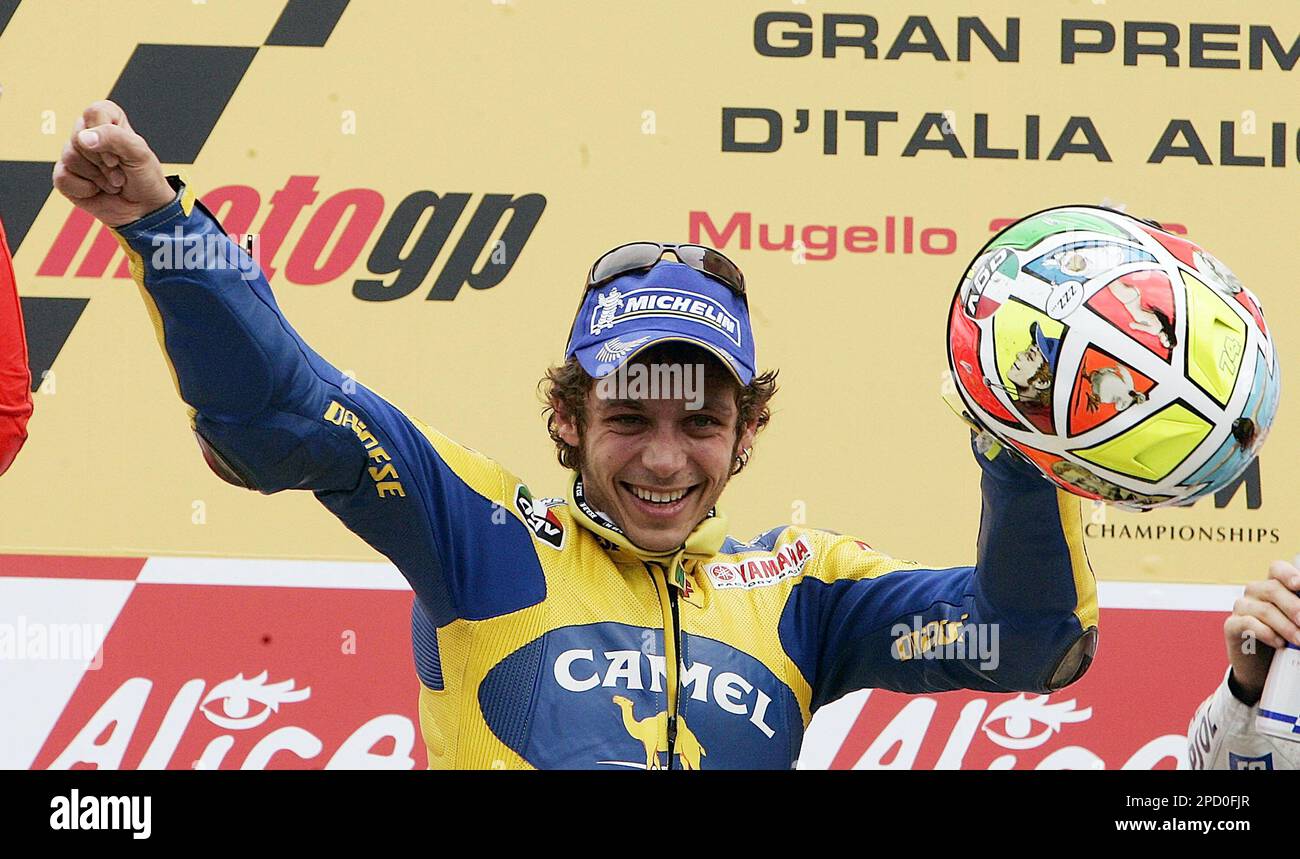 Italy's Valentino Rossi celebrates on the podium after winning the Moto ...