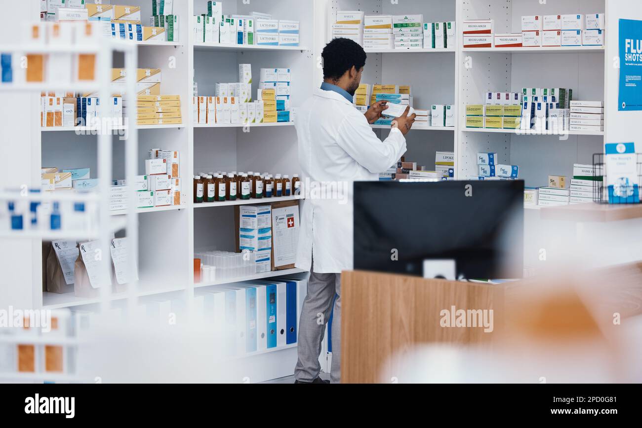 Black man pharmacist, pharmacy stock check and employee in a wellness ...