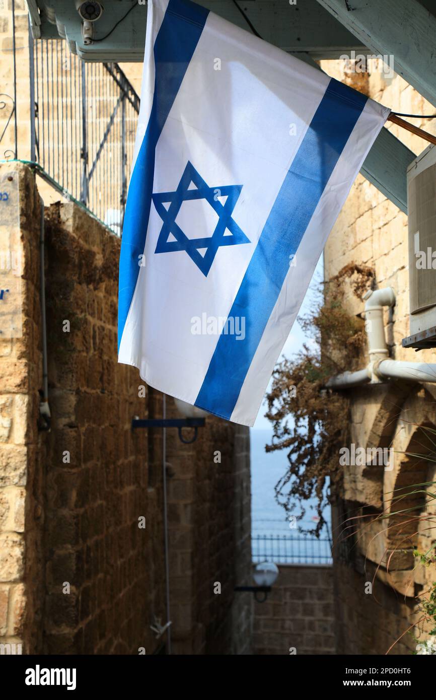 Flag of Israel in Jaffa district in Tel Aviv. Israeli national colors ...