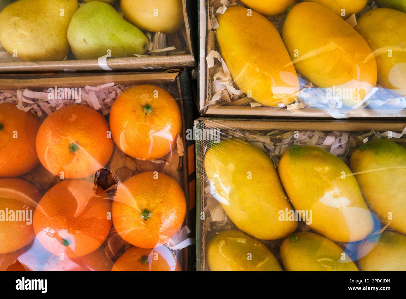 Sample of a gift bruit box, made of fake, plastic oranges, mangoes. At ...