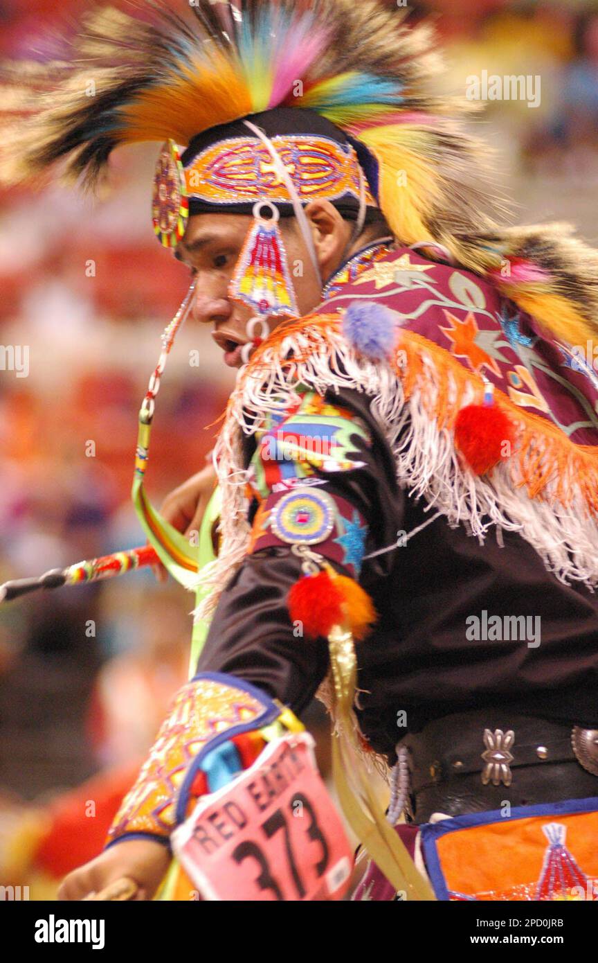 A native american dancer in full tribal regalia participates in a dance ...