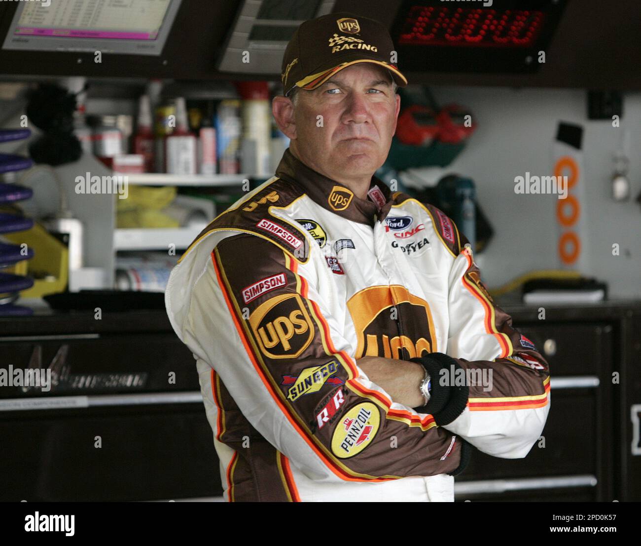 NASCAR driver Dale Jarrett looks around the garage area while his crew ...