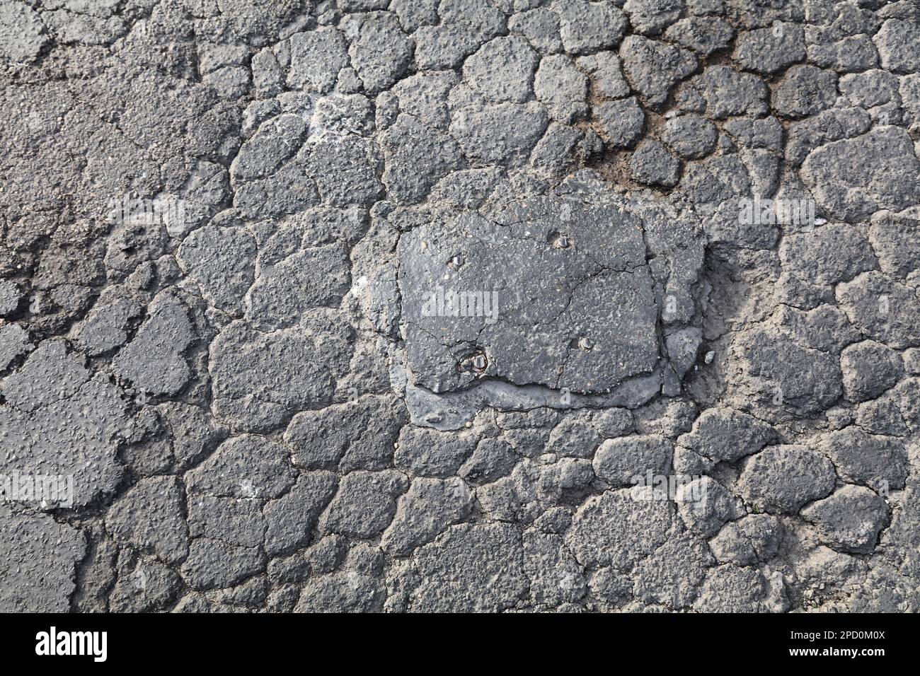 Damaged road. Bad road surface quality with multiple potholes and ...