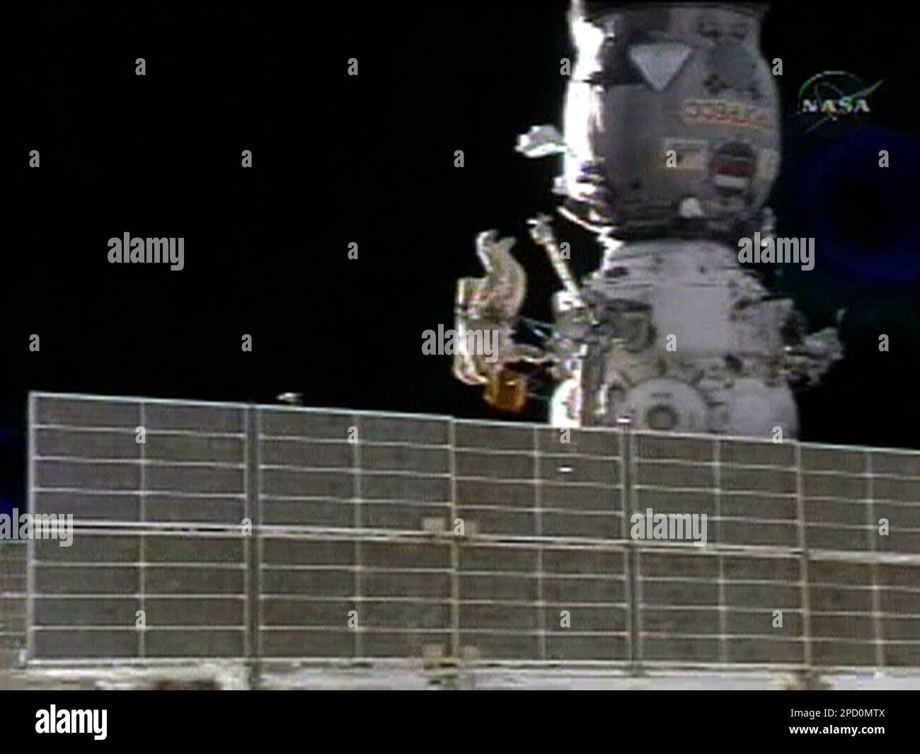 In this image made from NASA TV, Astronaut Jeff Willliams retrieves an ...