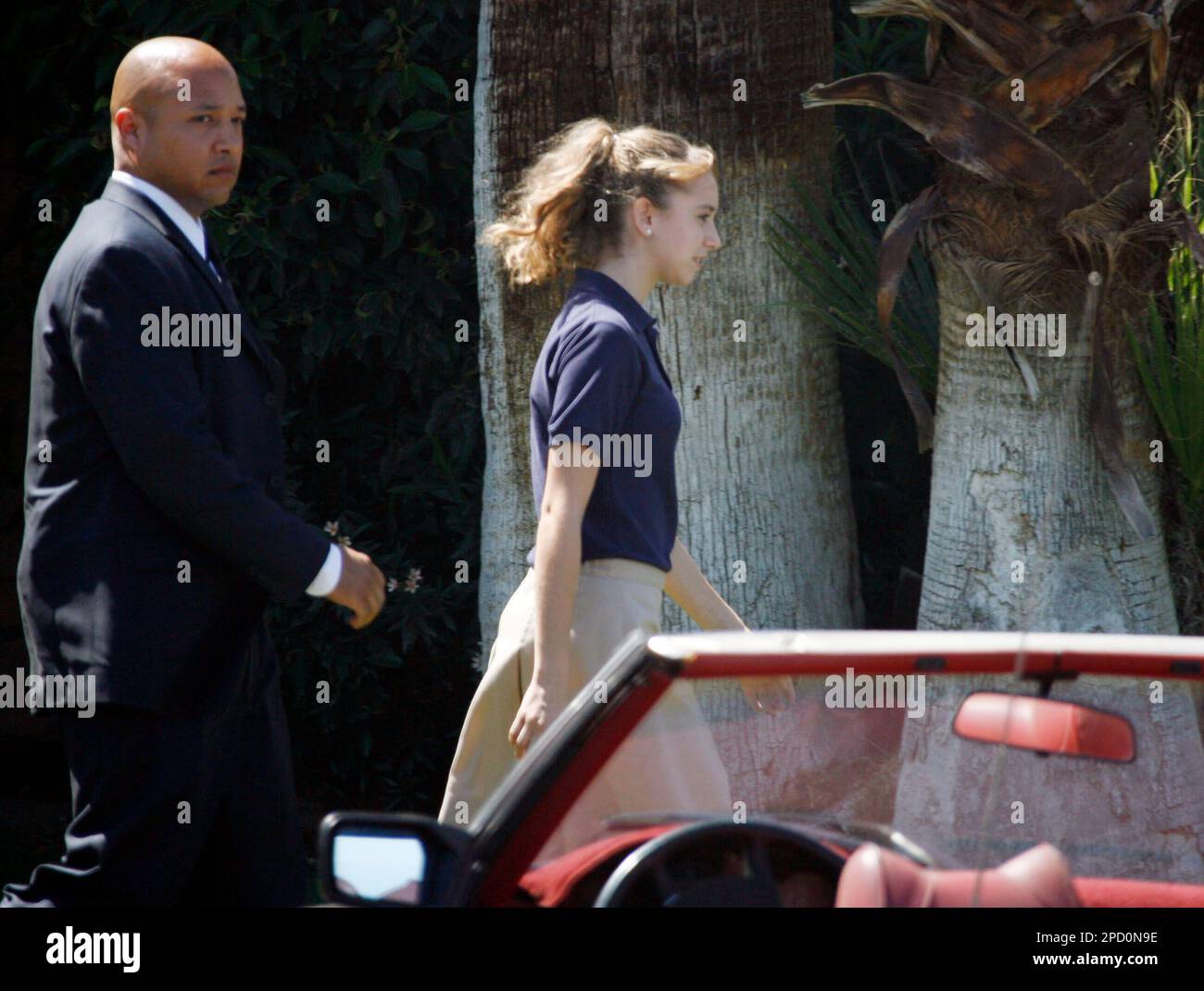 Security personnel escorts student Jazmin Grace Grimaldi, the 14-year ...