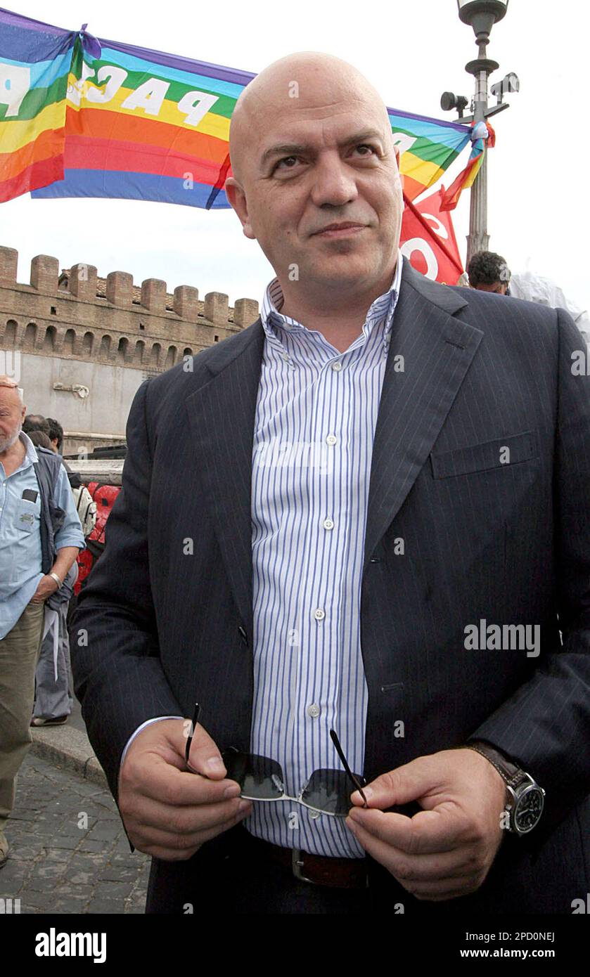 Italian Communist party's Marco Rizzo looks on under a peace flag ...