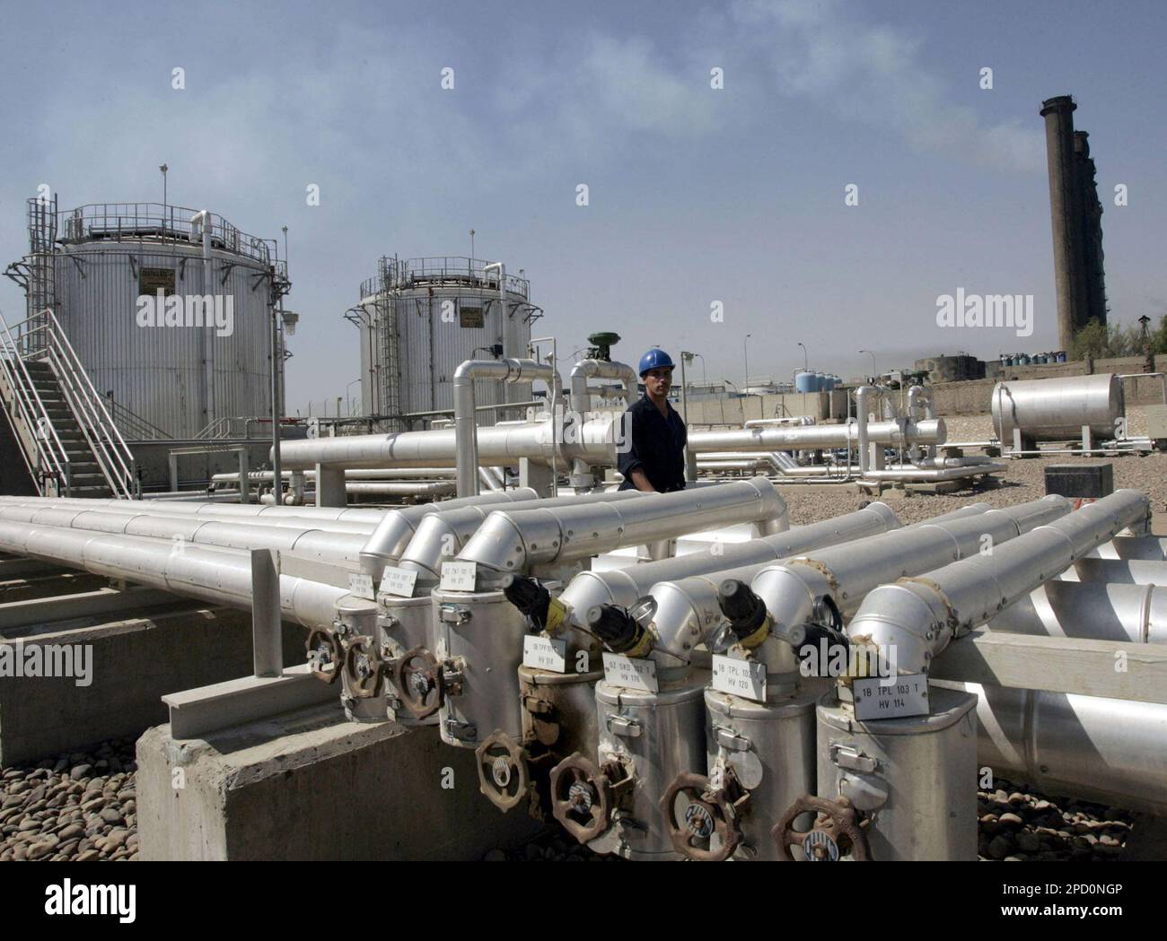 An Iraqi engineer performs his job inside the power plant after the ...