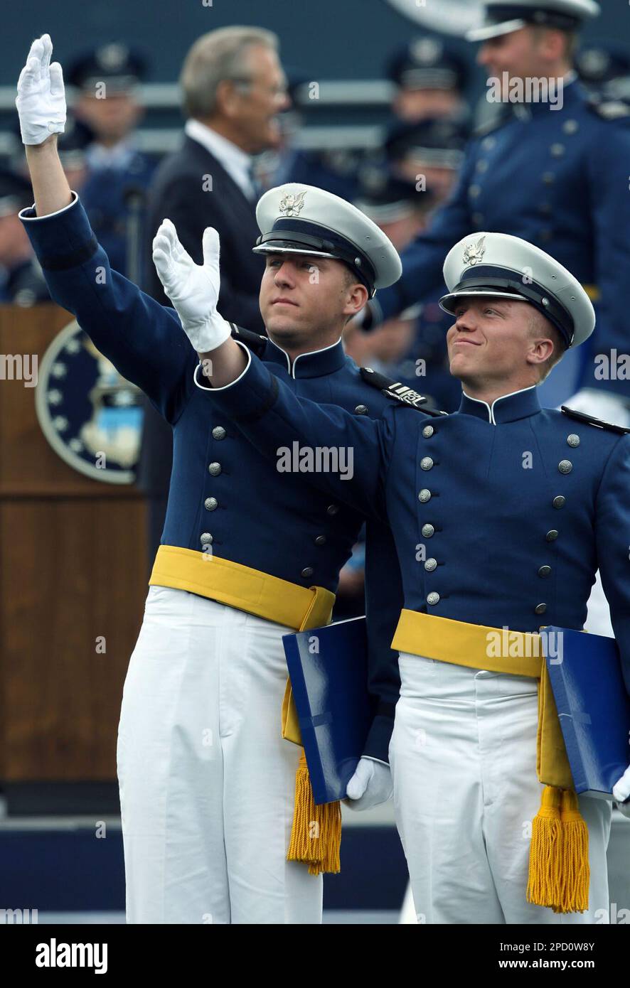 Cadets gesture to the crowd after receiving their diplomas during the ...