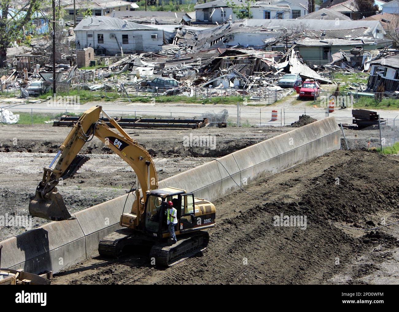 ** FILE ** Work continues on the rebuilding of the damaged levee in the ...