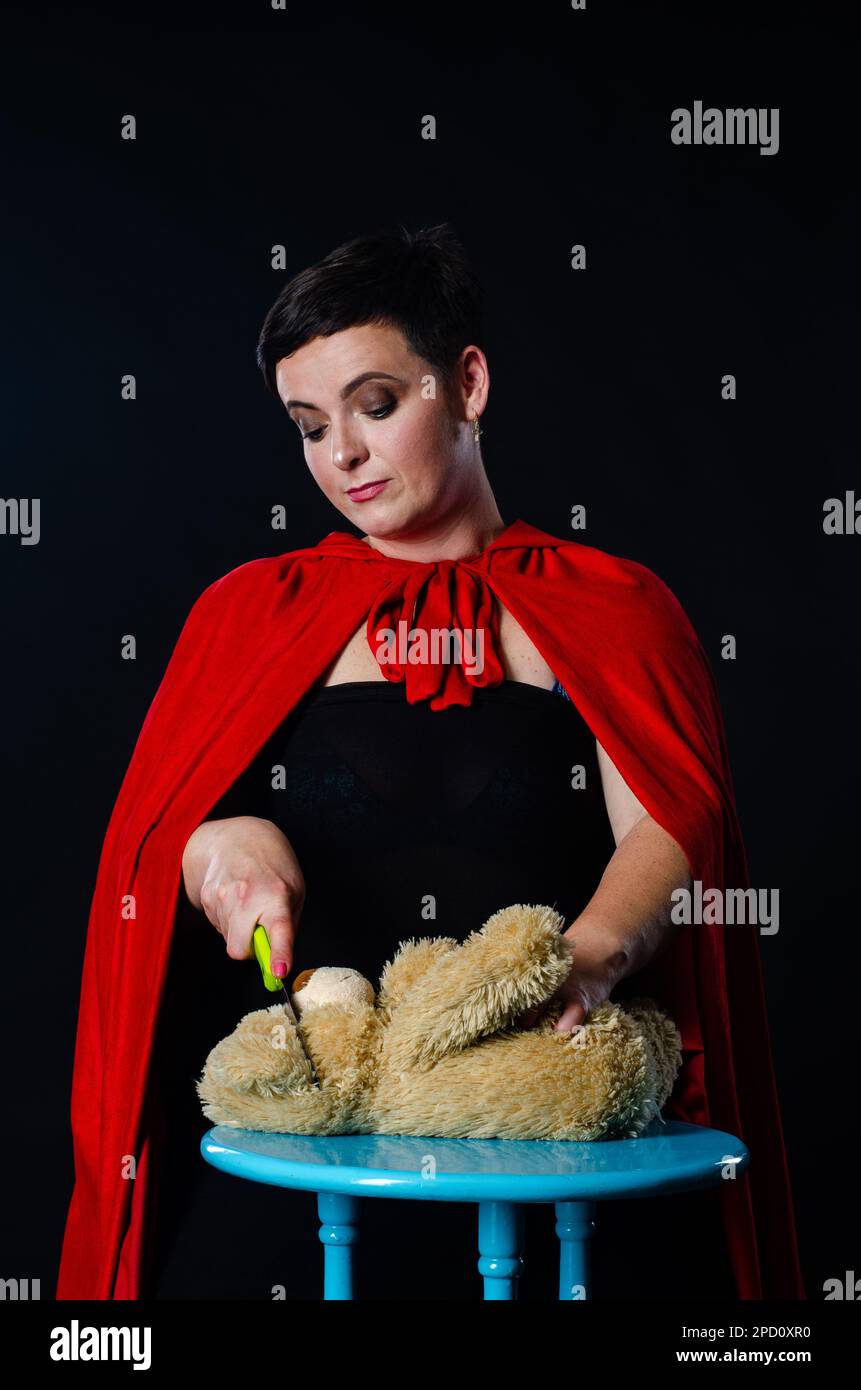 beautiful woman red cloak with red flowers roses in studio. Woman Red ...