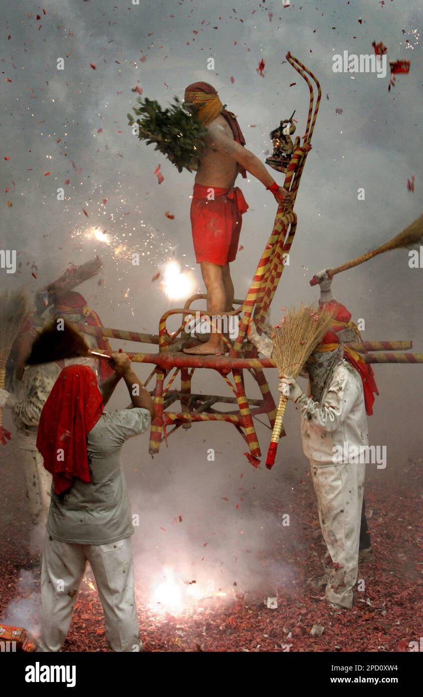 Taiwanese men perform Chinese folklore rituals to bring good luck and ...