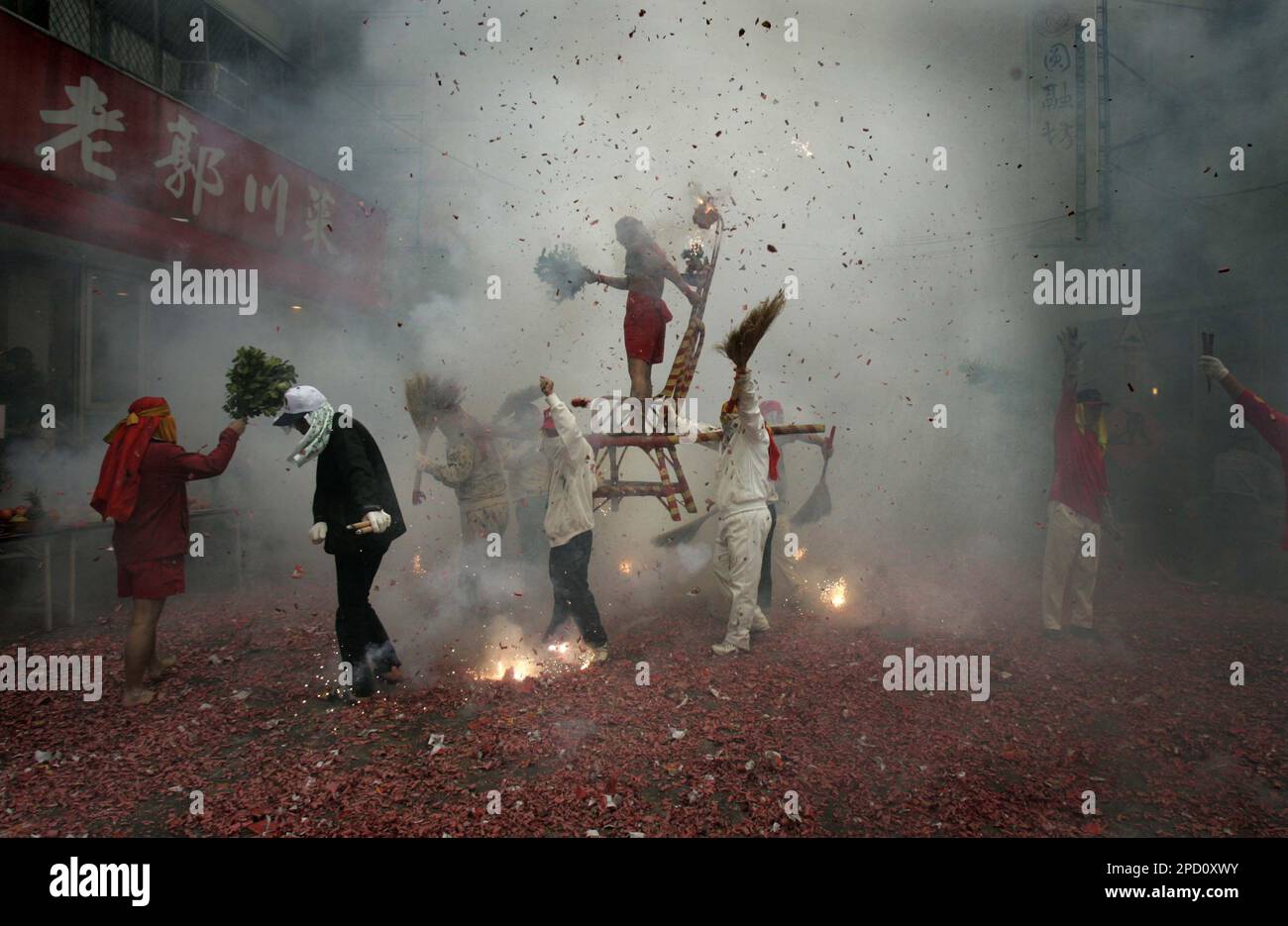 Taiwanese men perform Chinese folklore rituals to bring good luck and ...