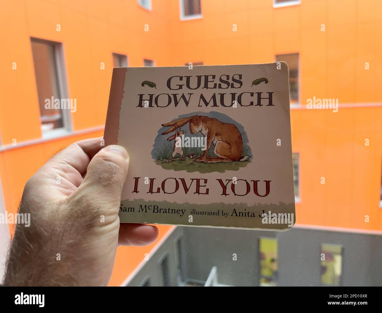 Paris, France - Oct 20, 2022: POV male hand reading a children's book ...