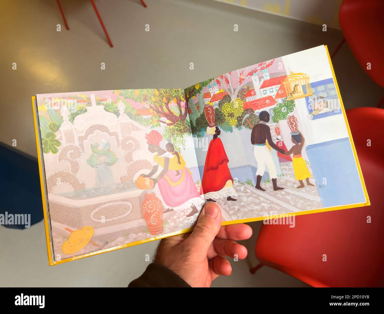 Paris, France - Oct 20, 2022: POV male hand reading a children's tales ...