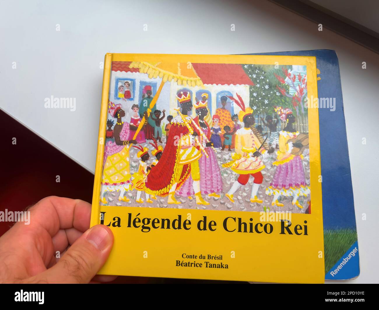 Paris, France - Oct 20, 2022: POV male hand reading a children's tales ...