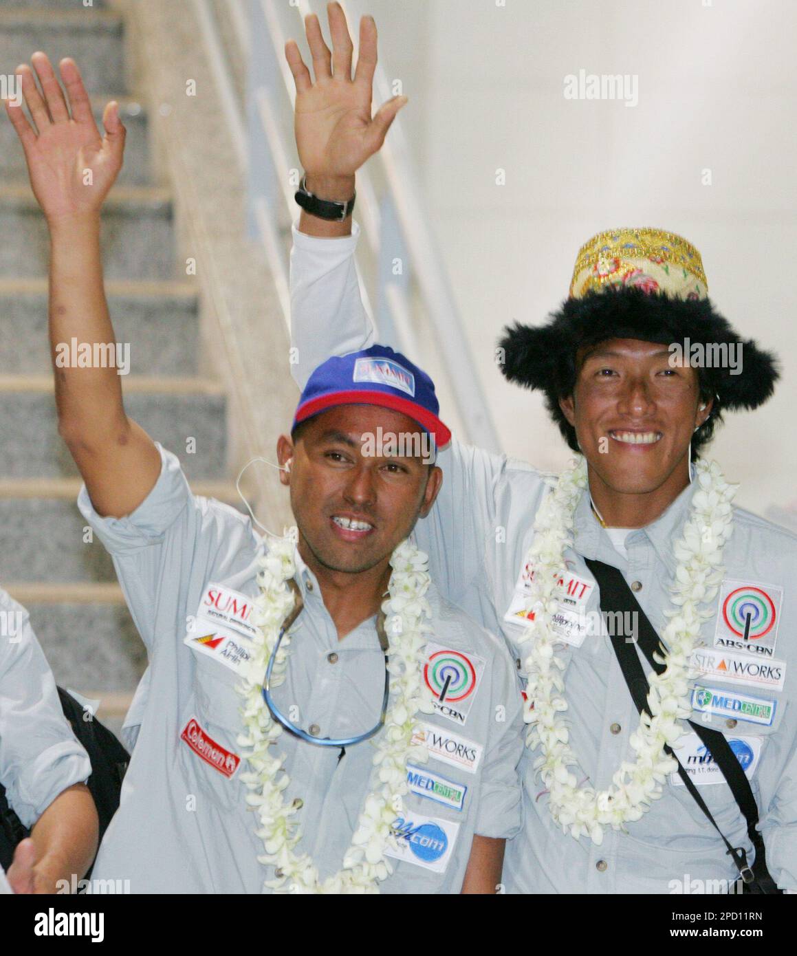 Filipino mountaineers Leo Oracion, right, and Erwin Emata, wave to well ...