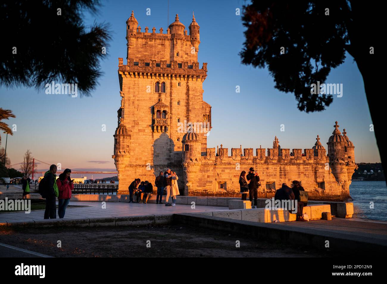 People enjoy a beautiful sunset from Belem Tower or Tower of St Vincent ...