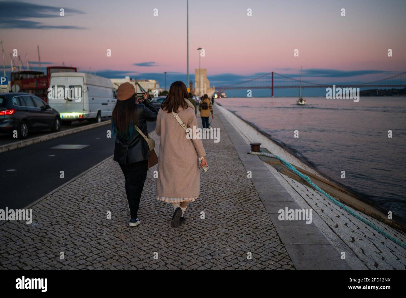 People enjoying the sunset in Belem promenade by Tagus River, Lisbon ...