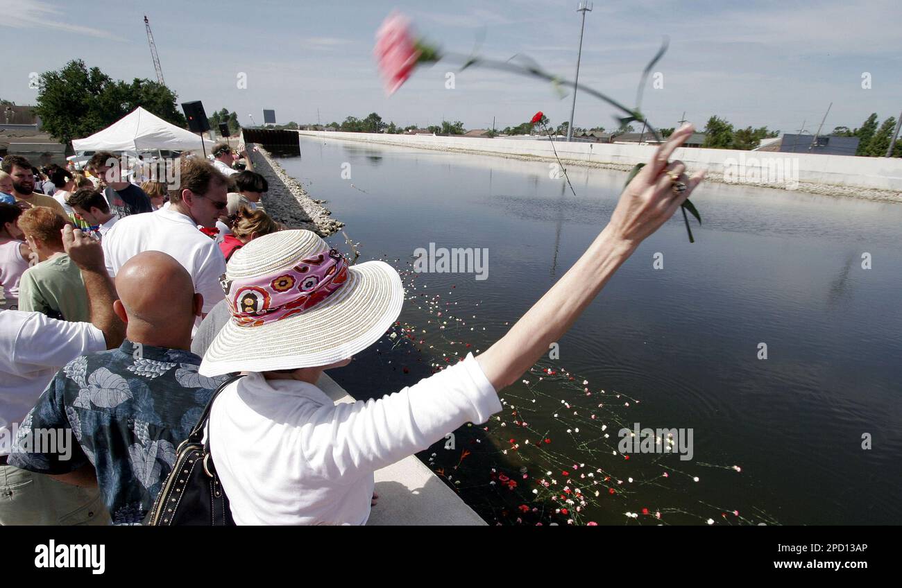 Jaye Parish-Graf throws a flower into the 17th Street Canal to remember ...