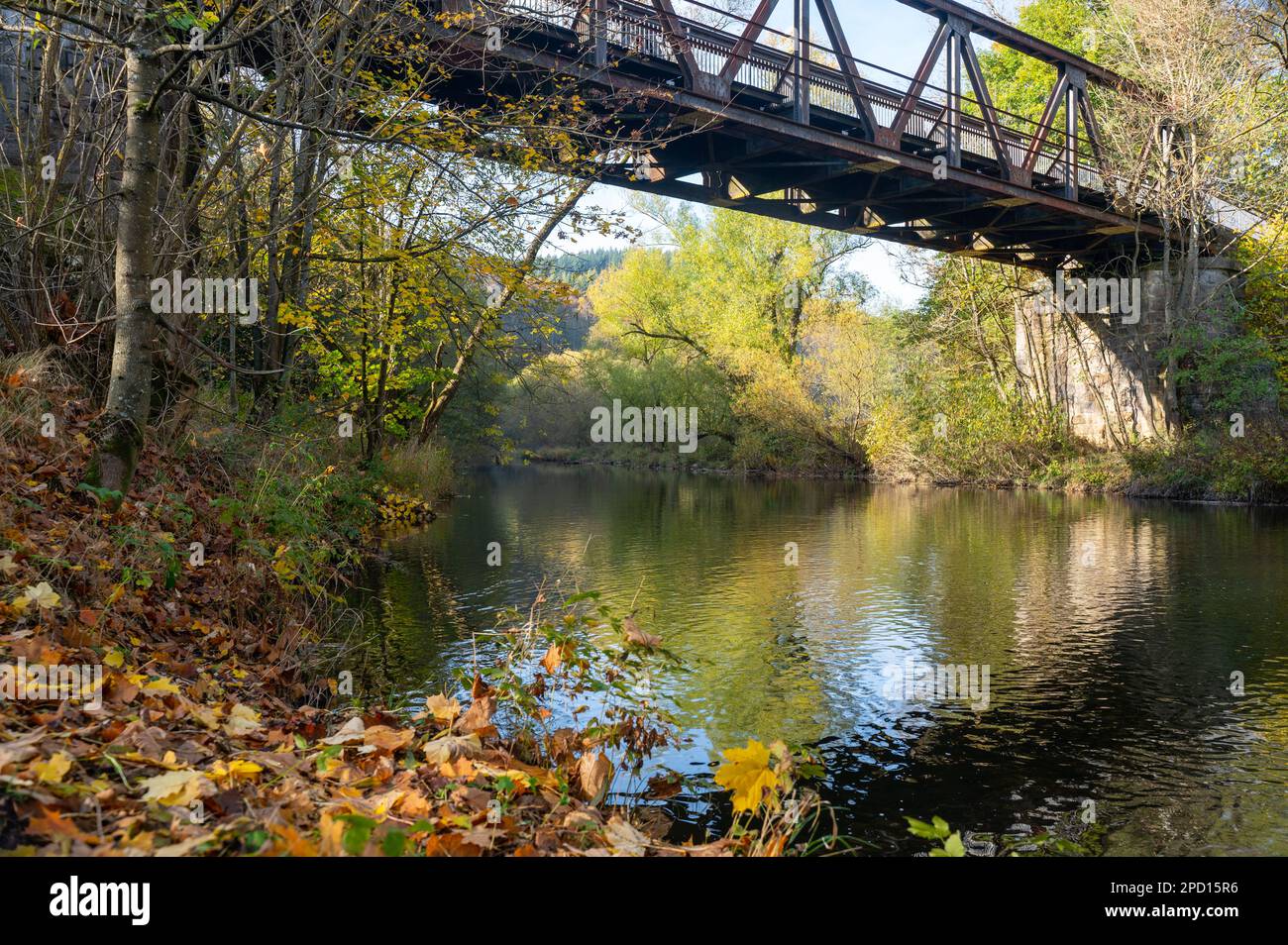 Old iron bridge over the river Eder with banks and trees in Hesse ...