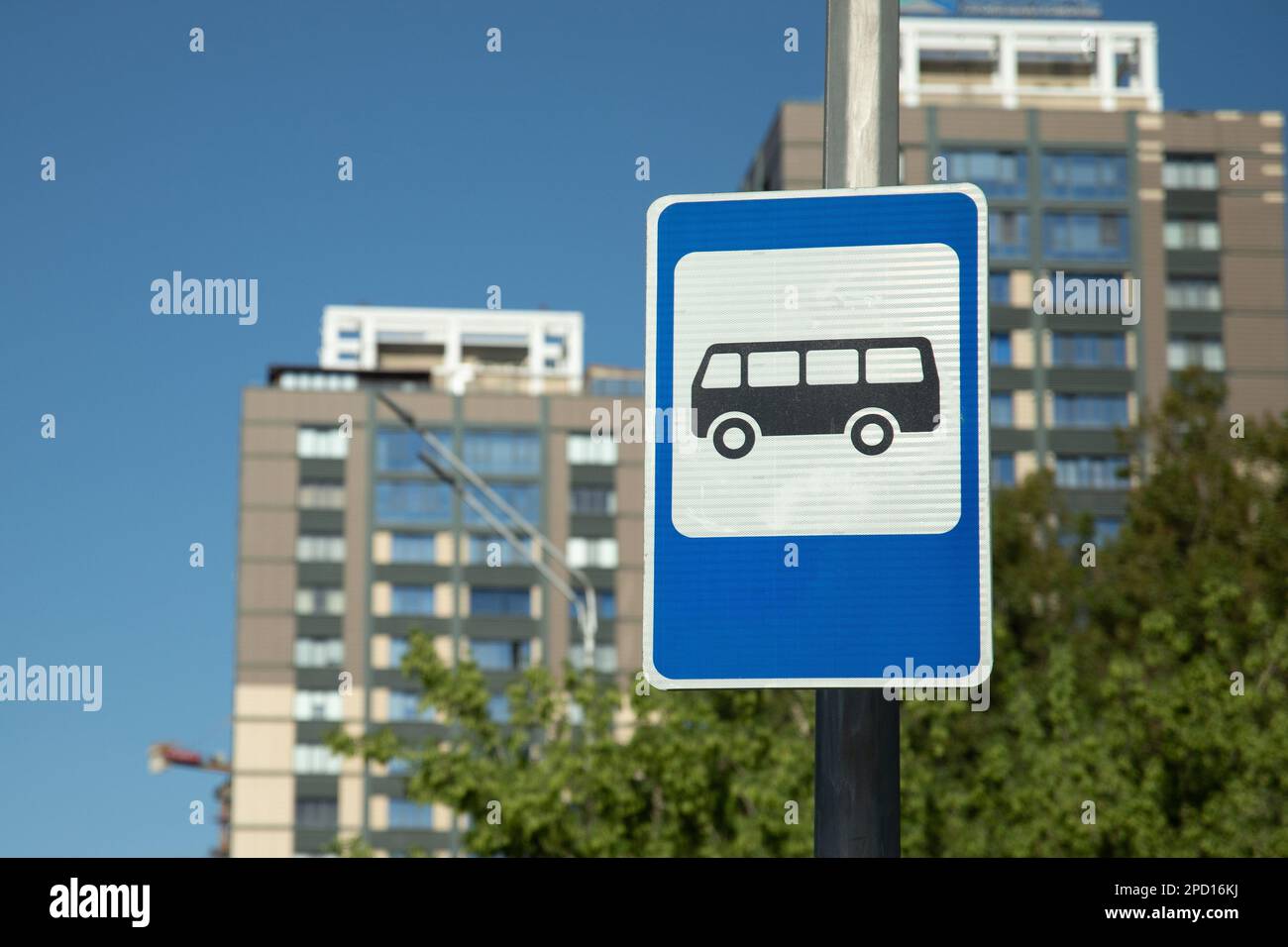 Blue bus stop sign on the background of a residential complex Stock ...