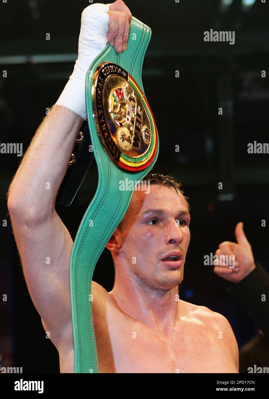 German boxer Mario Veit raises the international Champion's belt as he ...