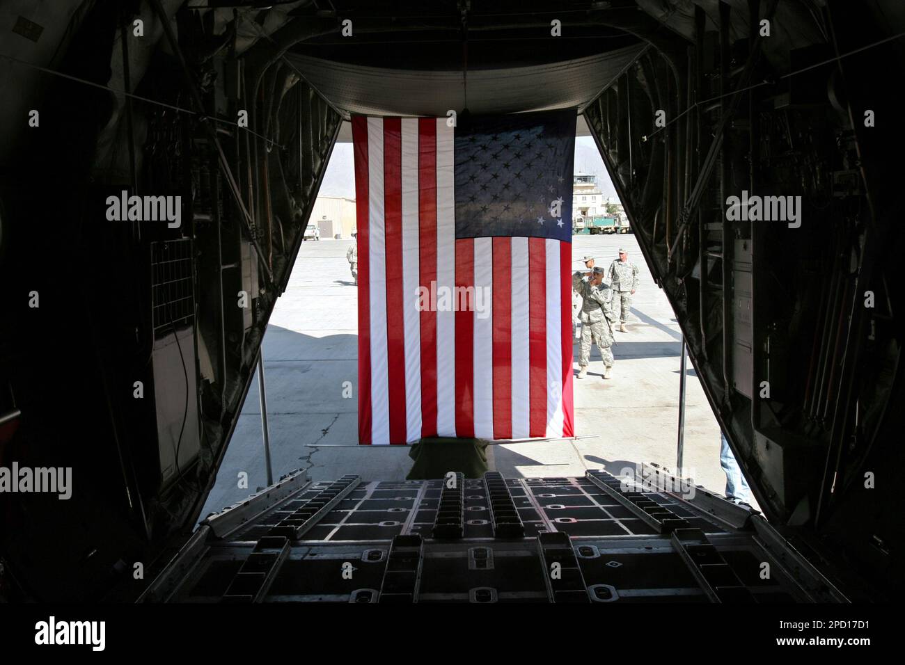 A U.S. flag is seen hanging in the back of a military plane after a ...