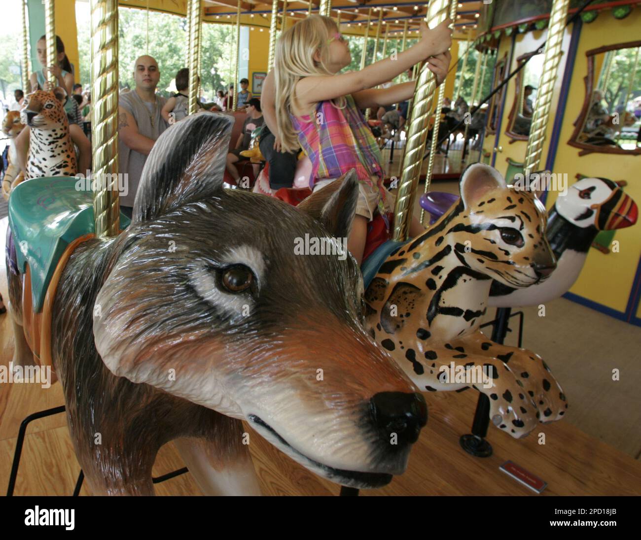 Paige McCoy rides a leopard cub on Brookfield Zoo's new carousel ...