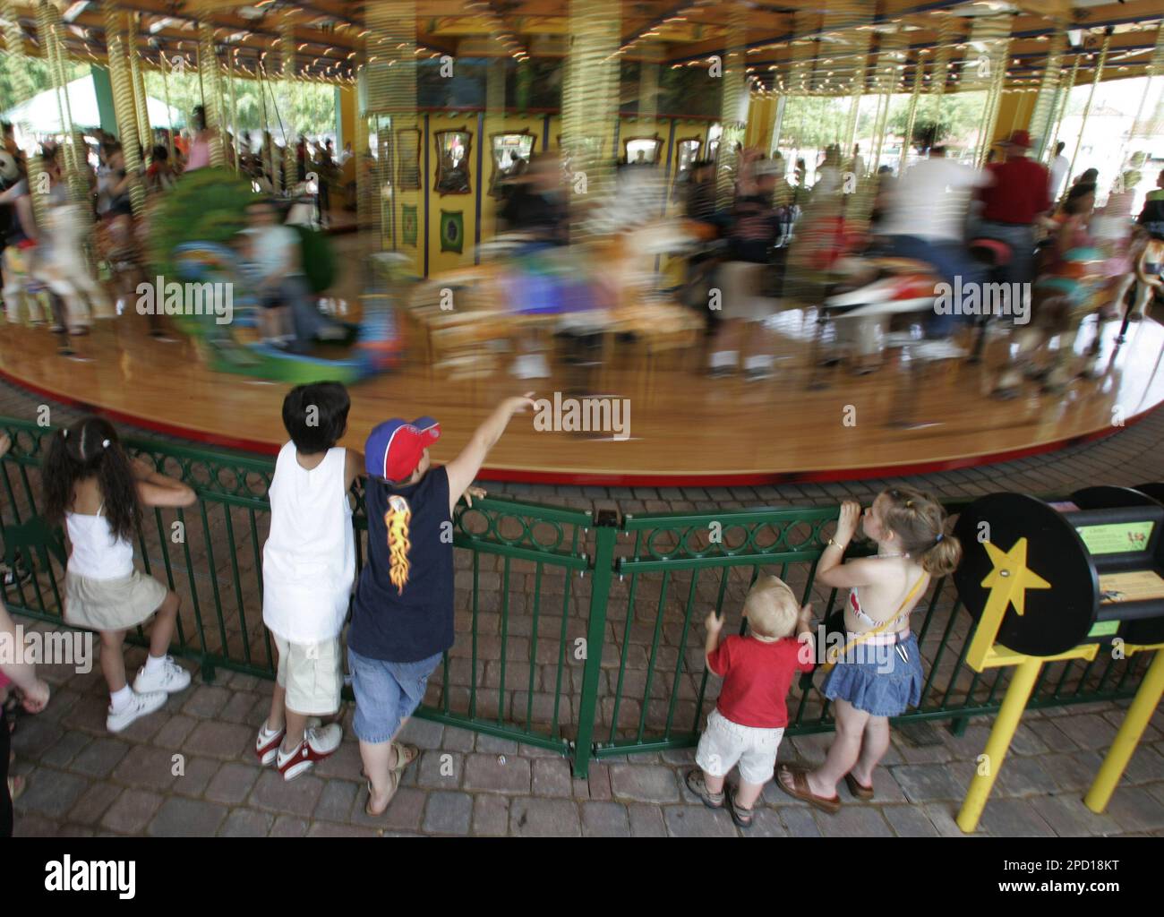 Children wait in line to ride the Brookfield Zoo's new carousel ...