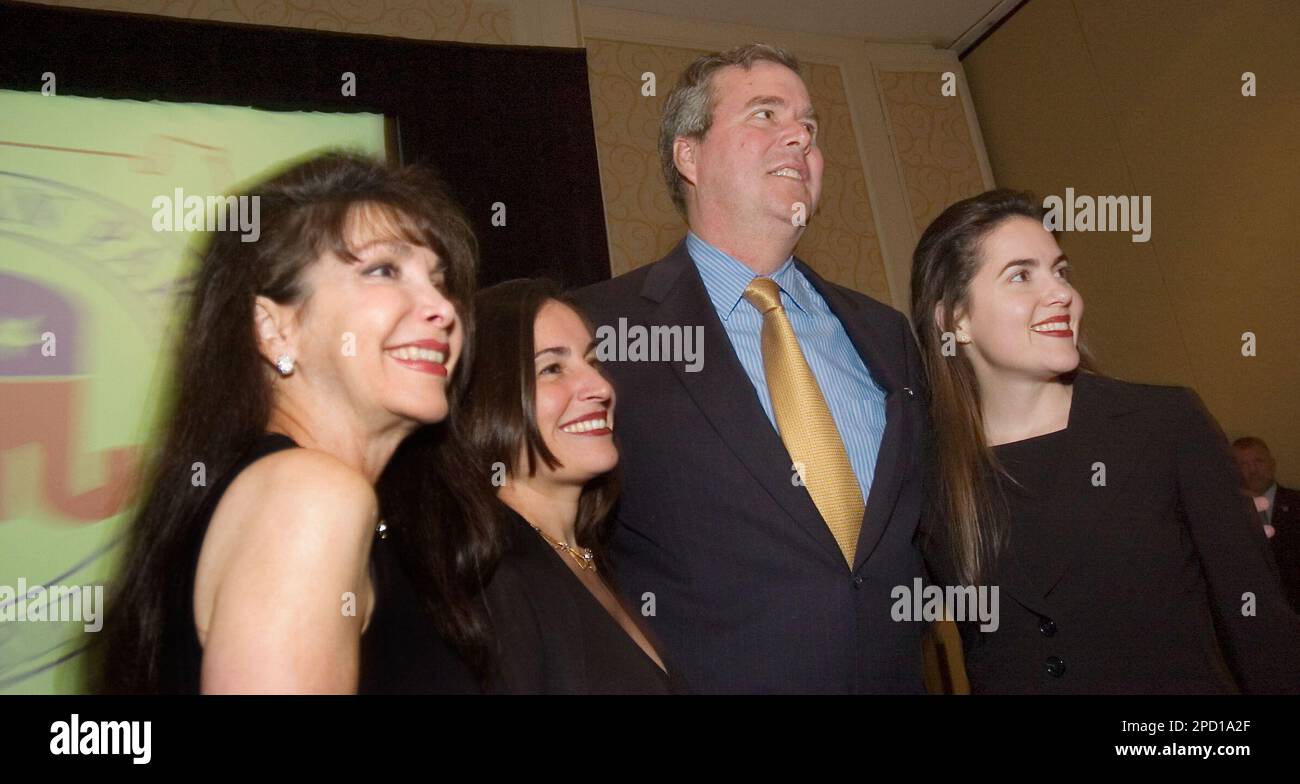 Florida Gov. Jeb Bush poses with supporters, from left, Anolan Ponce ...