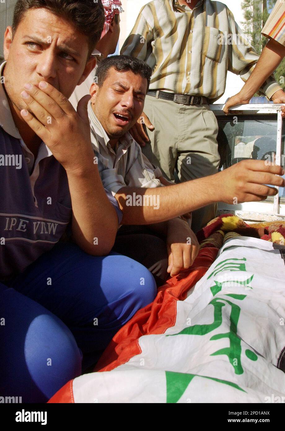 Brothers of Iraqi Police Lt. Colonel Hashim Mahmoud, who was shot dead ...