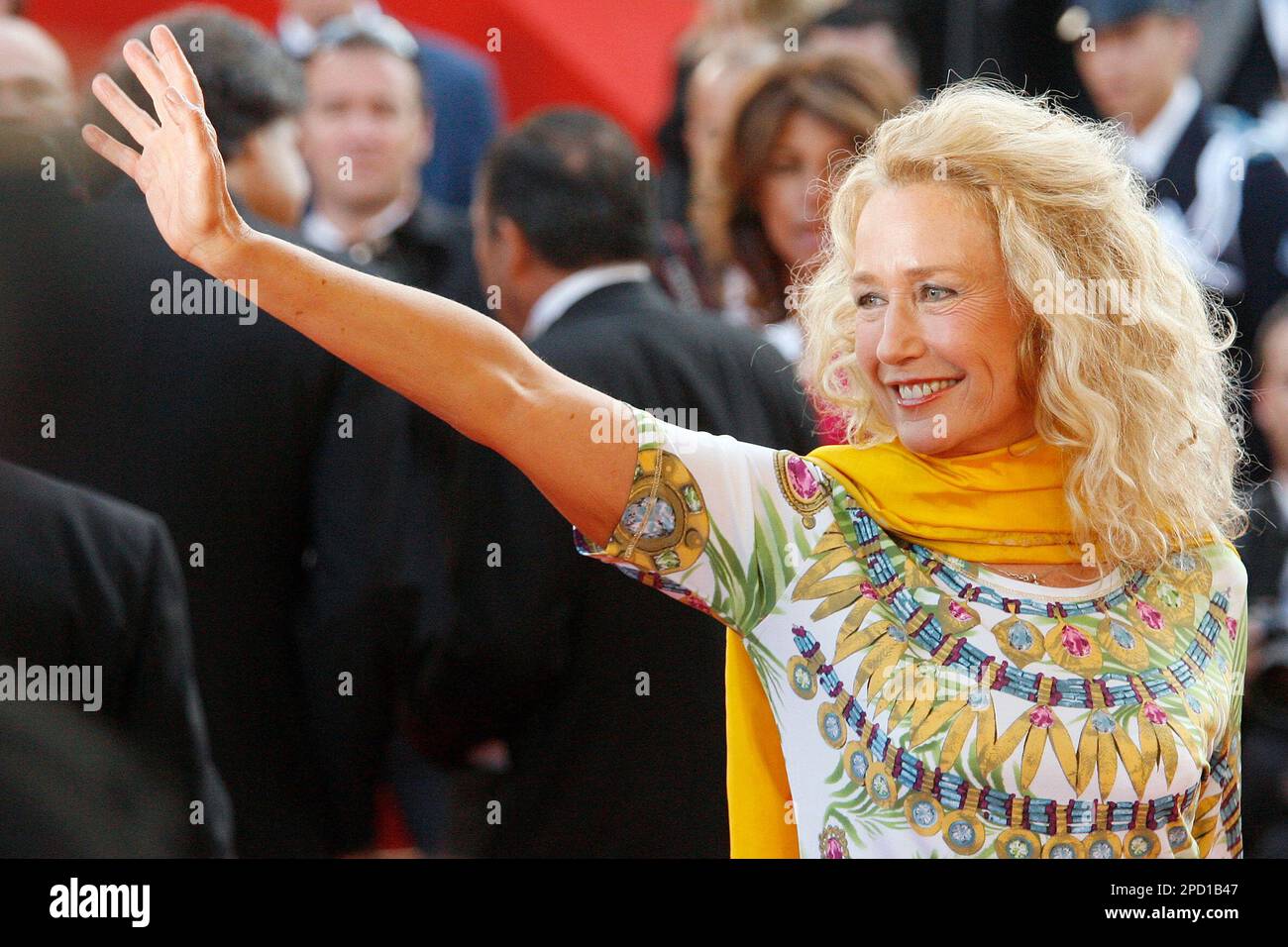 French actress Brigitte Fossey waves as she arrives for the screening ...