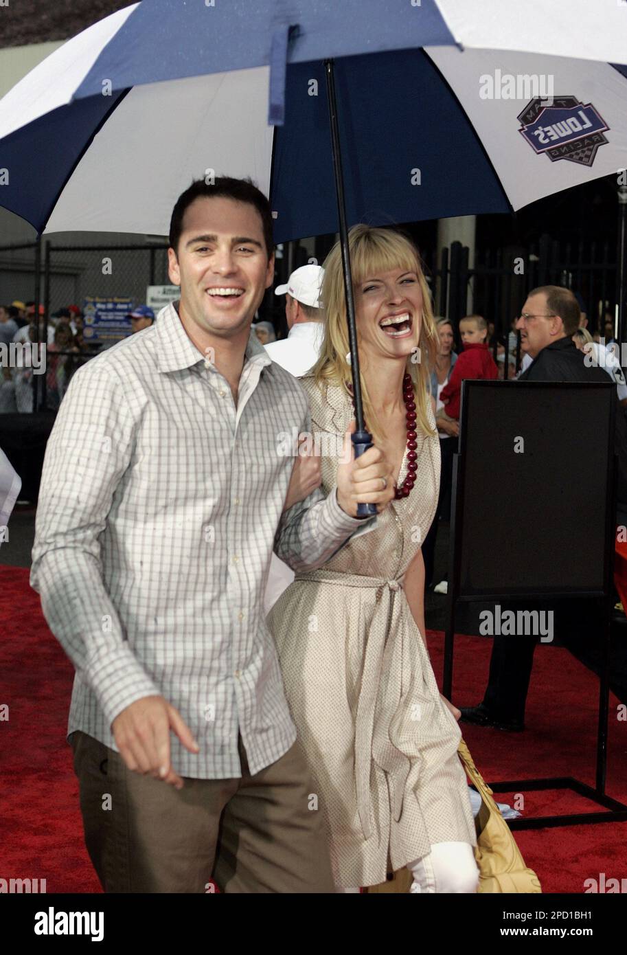 NASCAR driver Jimmie Johnson, left, arrives with his wife, model ...
