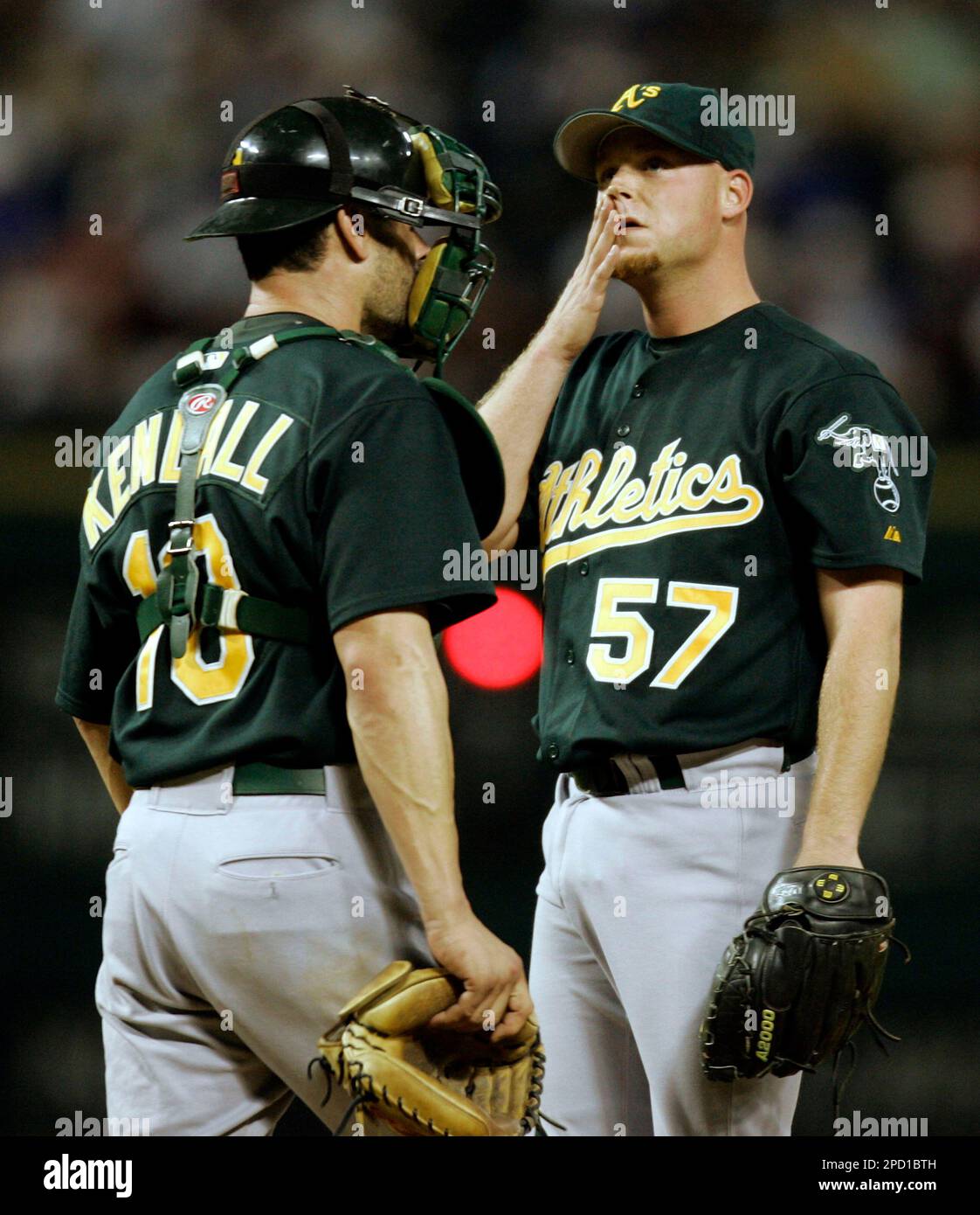 Oakland Athletics pitcher Chad Gaudin (57) wipes his face as catcher ...