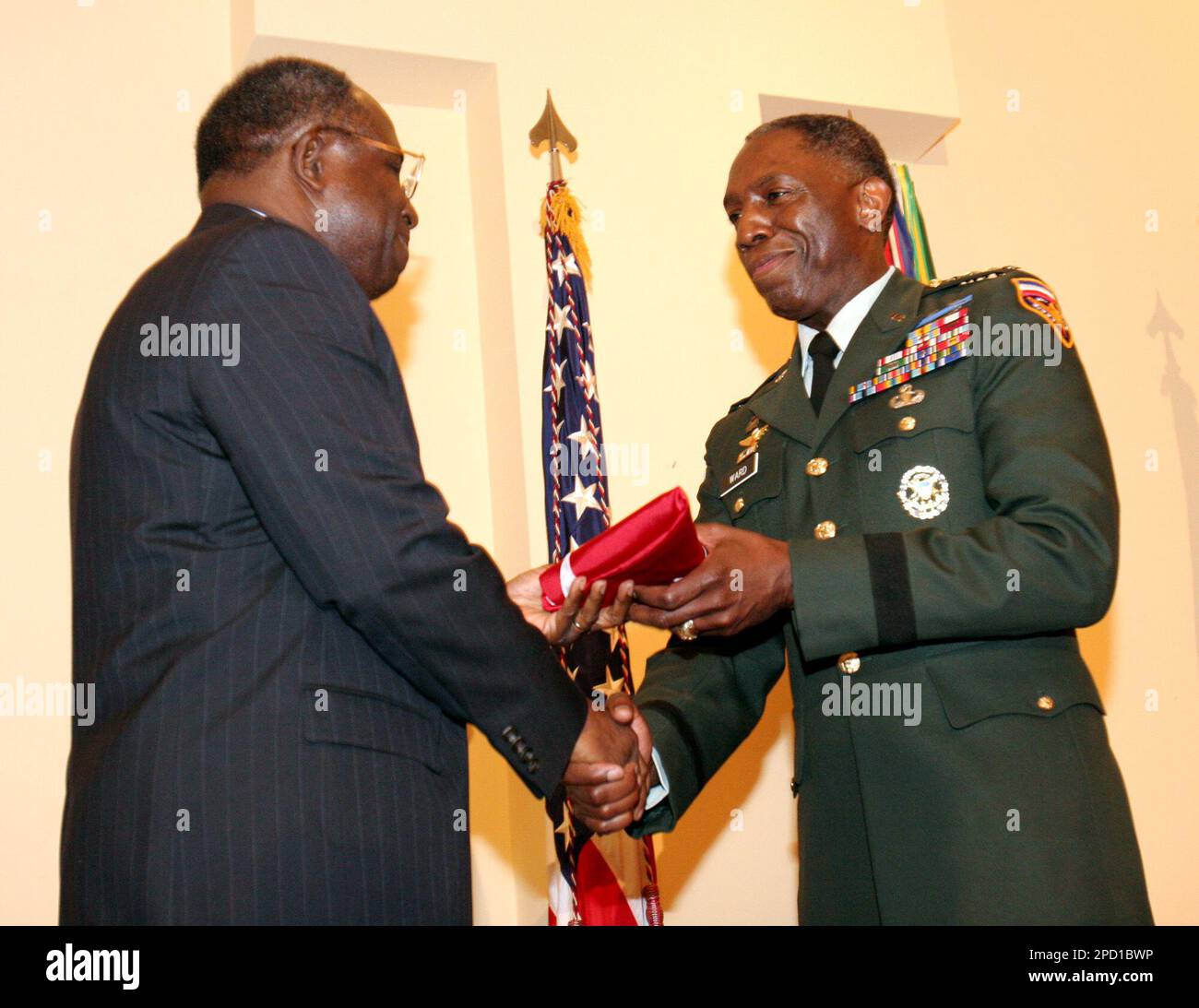 Army Lt. Gen. William E. Kip Ward, right, is presented with the Four ...