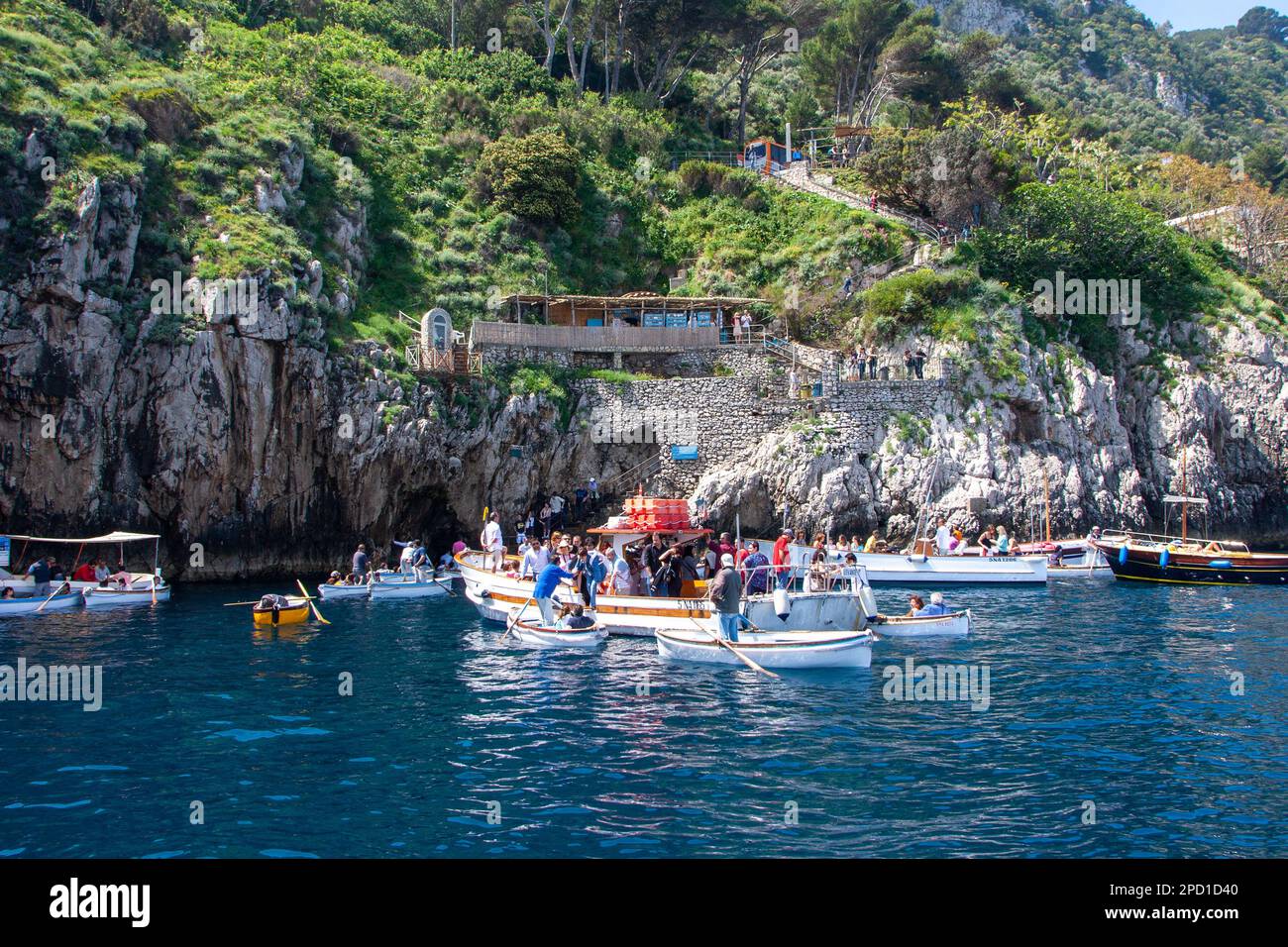 Boats and rowboats at the entrance to the Blue Grotto, Capri, Italy ...