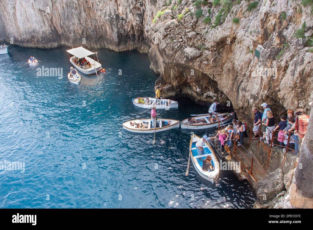 Boats and rowboats at the entrance to the Blue Grotto, Capri, Italy ...