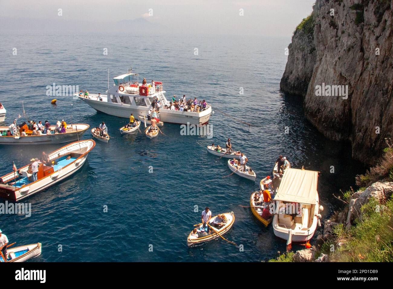 Boats and rowboats at the entrance to the Blue Grotto, Capri, Italy ...
