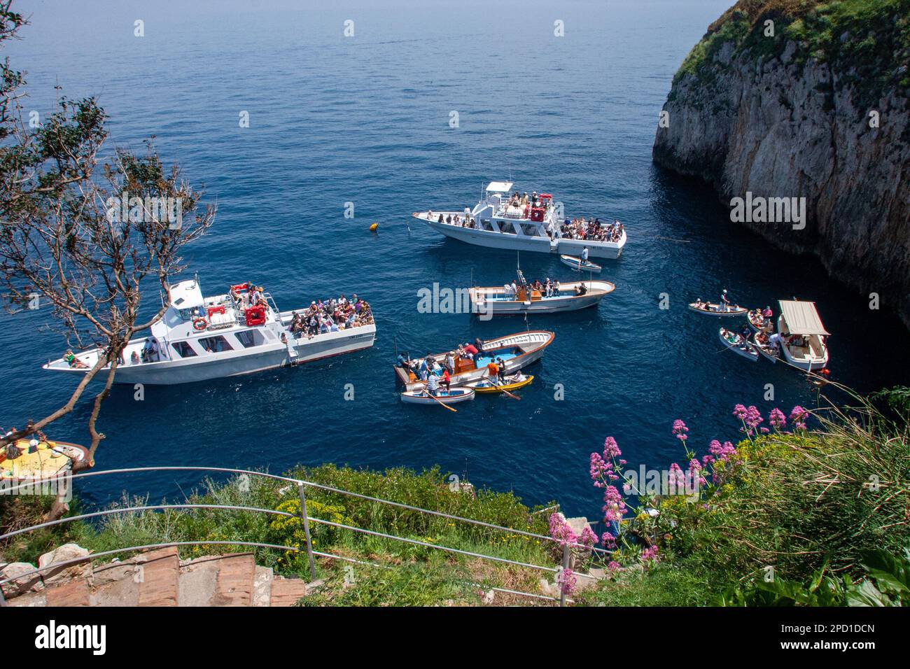 Boats and rowboats at the entrance to the Blue Grotto, Capri, Italy ...