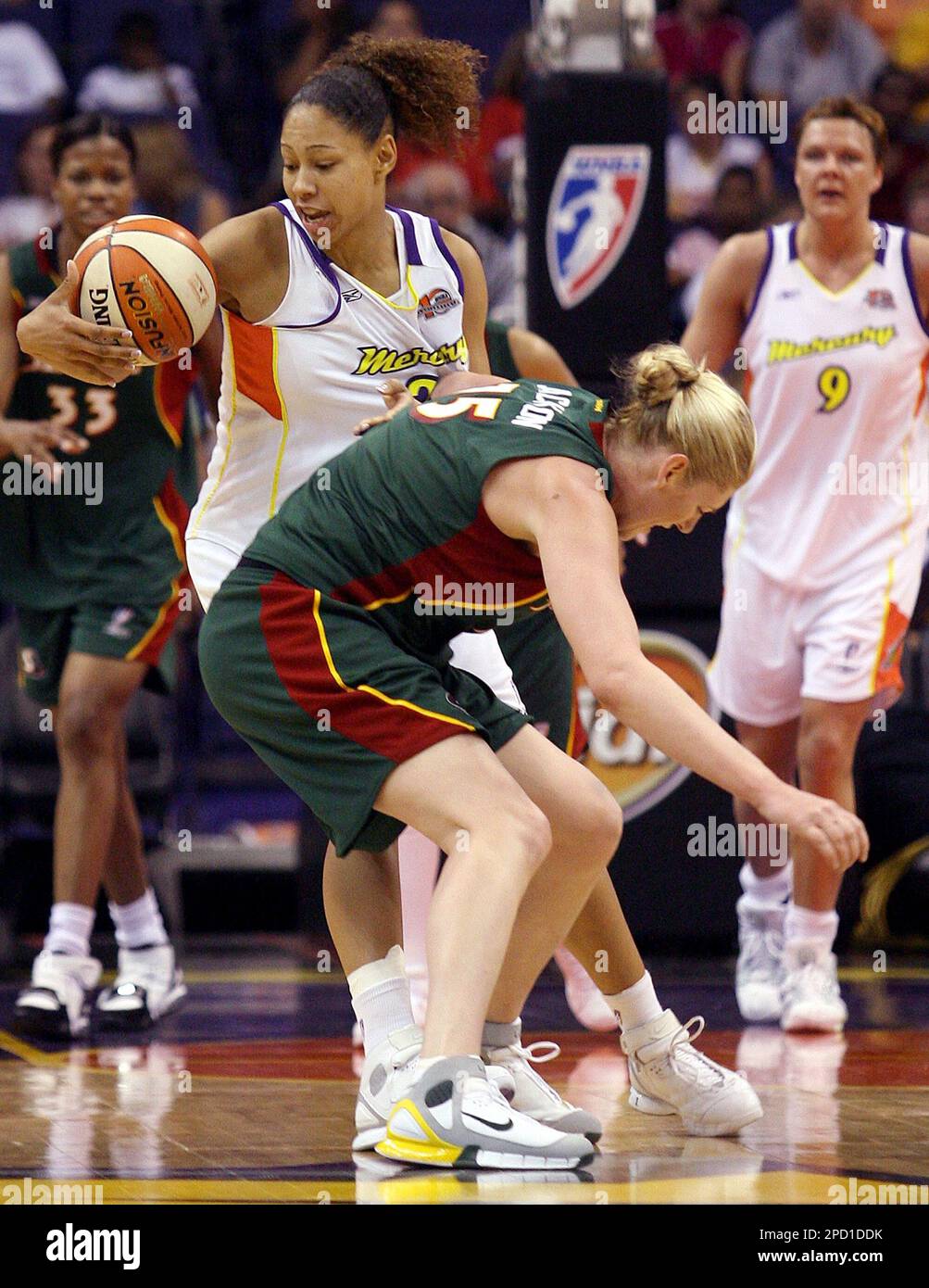 Phoenix Mercury forward Jennifer Lacy, left, gains control of a loose ...