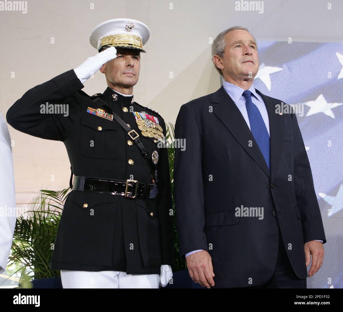 President Bush, right, stands with Gen. Peter Pace, left saluting ...