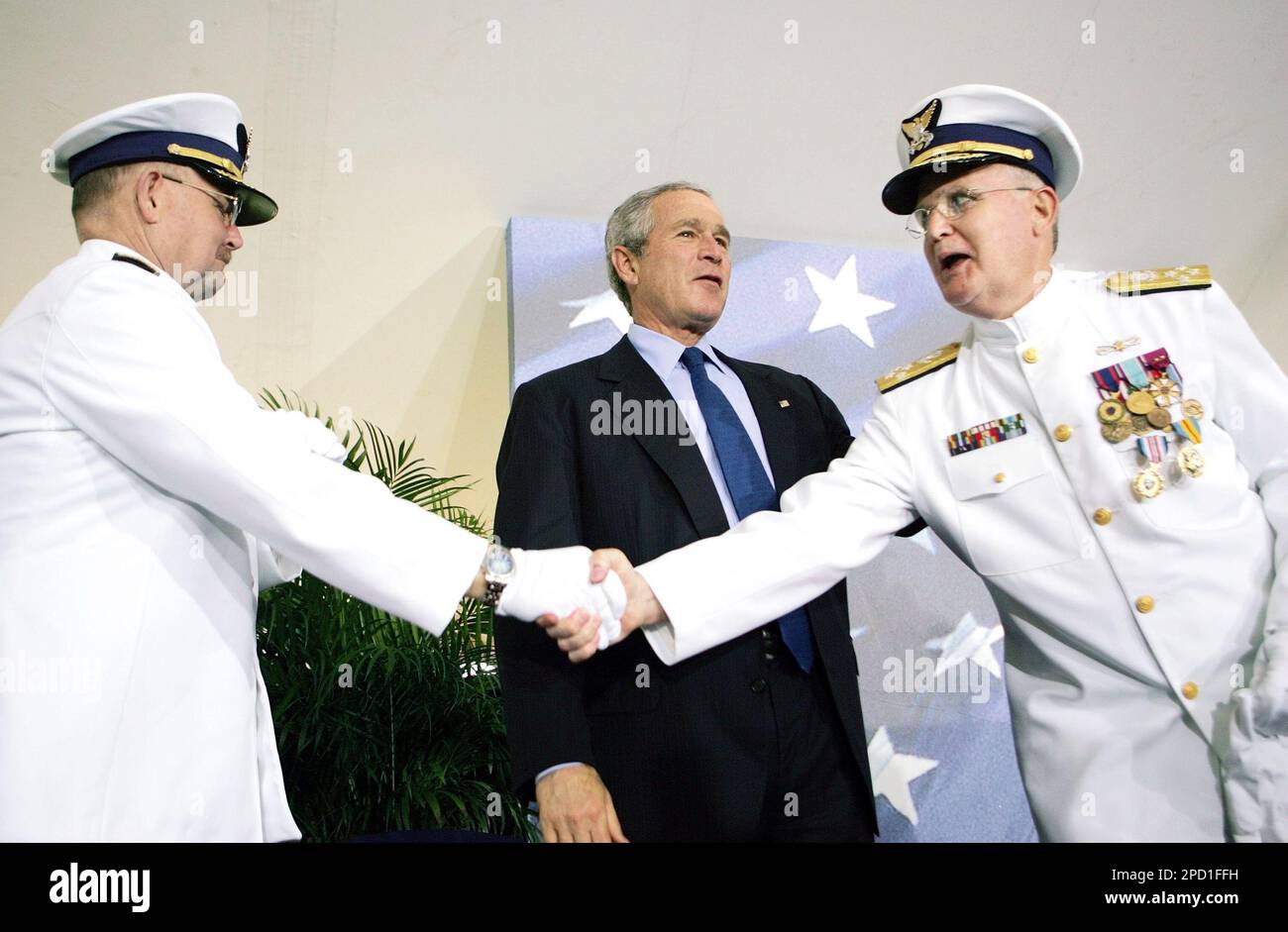 President Bush, center, watches as retiring Admiral Thomas H. Collins ...