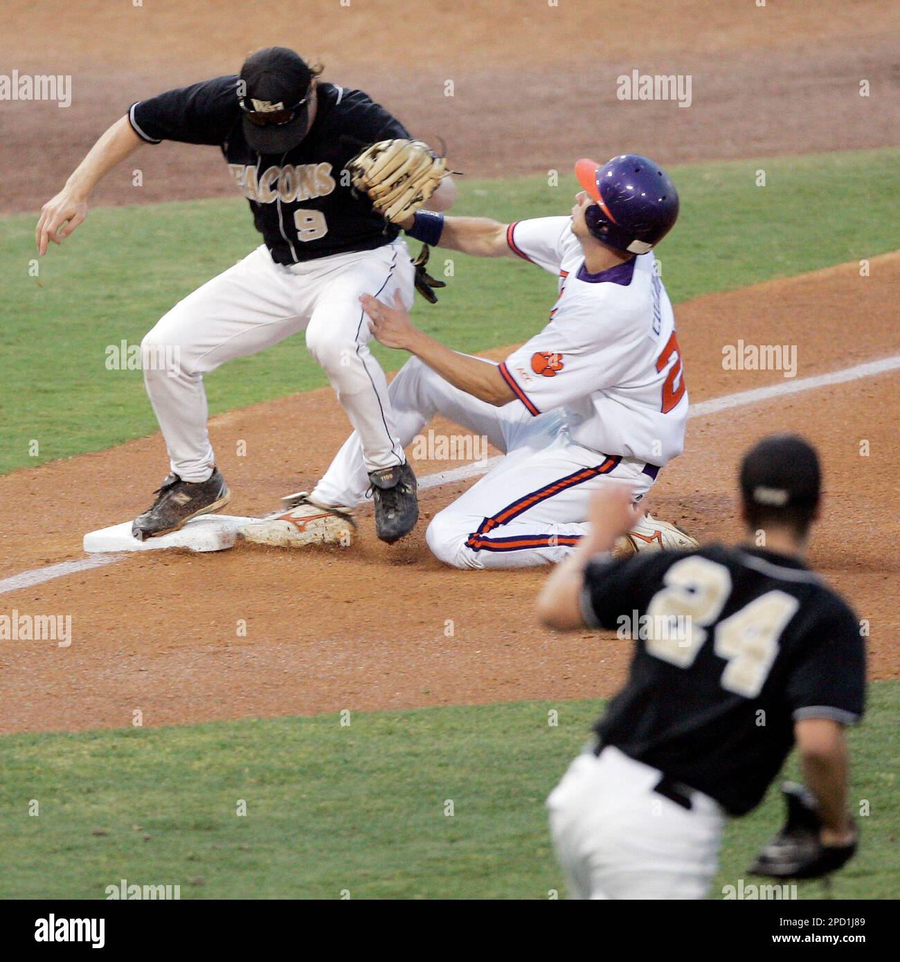 Clemson's Tyler Colvin is forced out at third base by Wake Forest's ...