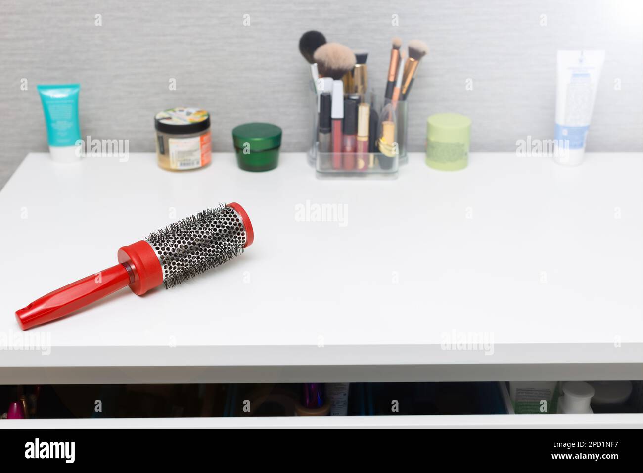 an old comb lies on the dressing table. red hair comb. hairbrush in the ...