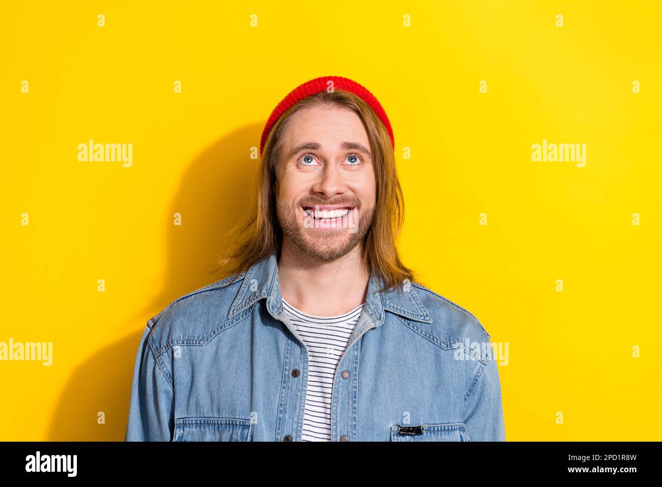 Photo of funky excited guy dressed jeans shirt looking up emtpy space ...